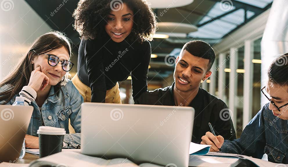 Four Students Using Laptop for Research at Library Stock Image - Image ...