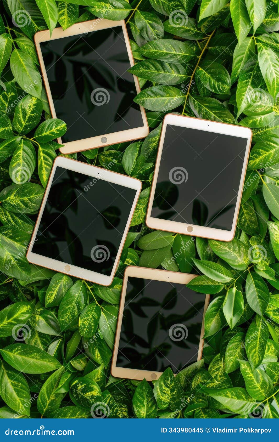 Four Tablets Sit on a Lush Green Plant, Ideal for Office or Home Use ...