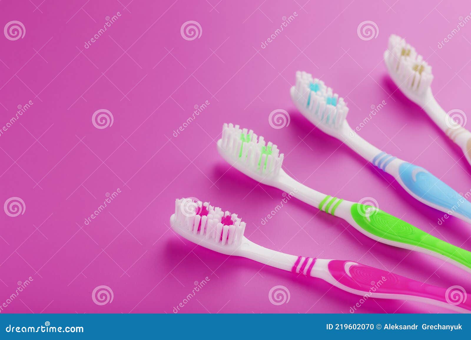 Four Toothbrushes on a Pink Background in a Row Stock Photo - Image of ...