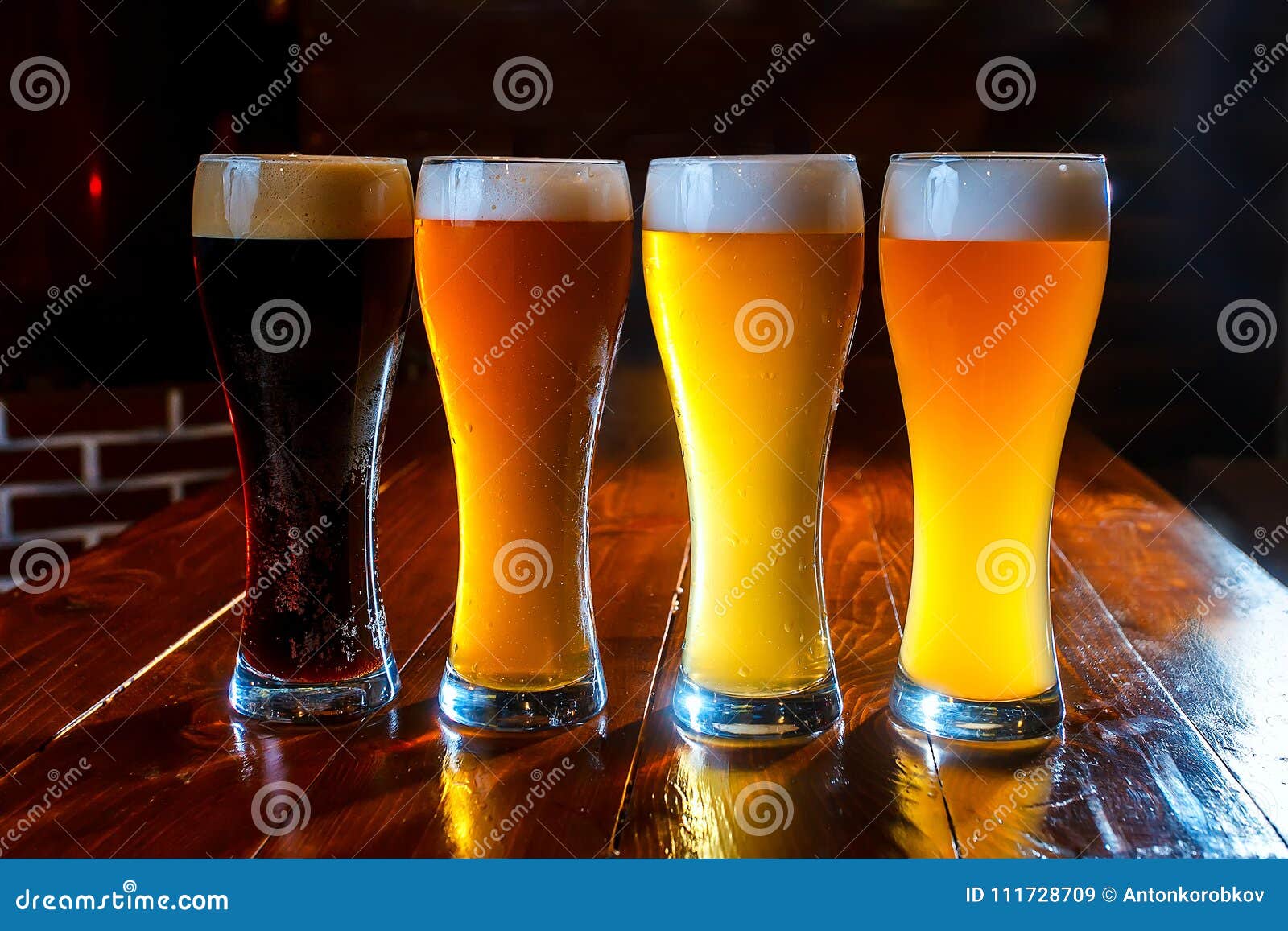Four Types of Beer: Dark, Light, Red, White. in a Dark Pub Stock Image ...