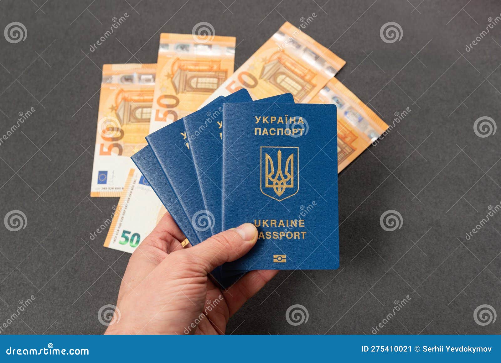 Four Ukrainian Passports In Men S Hand Cash Euros On Background