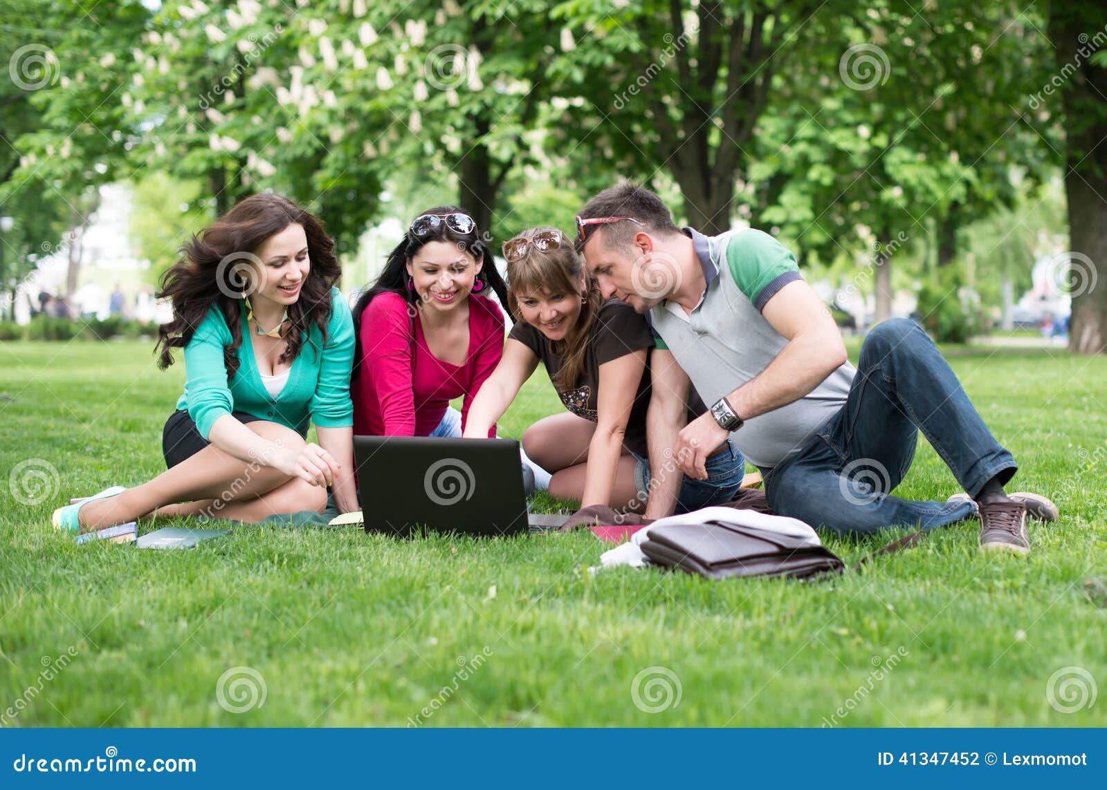 Four University Students Comparing Their Notes Stock Photo - Image of ...
