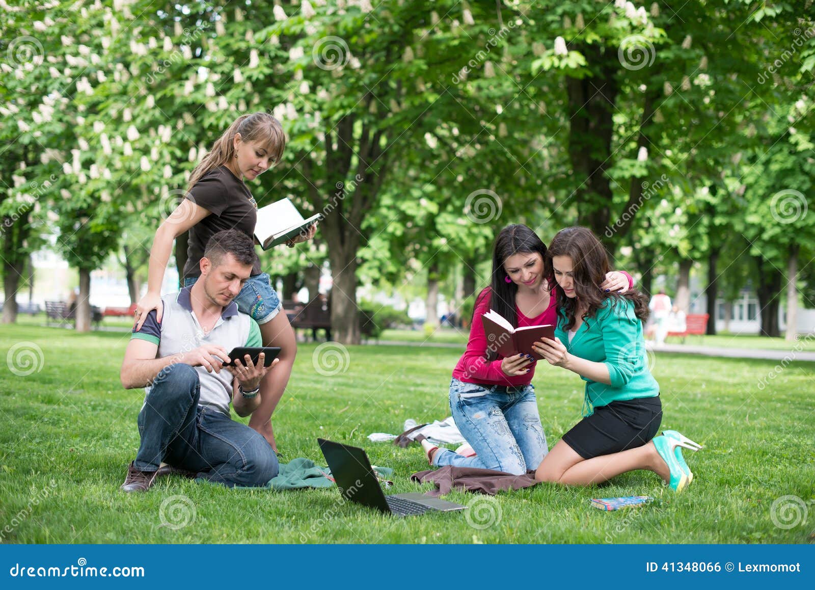 Four University Students Comparing Their Notes Stock Photo - Image of ...