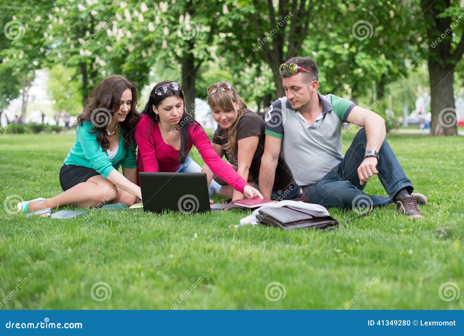 Four University Students Comparing Their Notes Stock Photo - Image of ...
