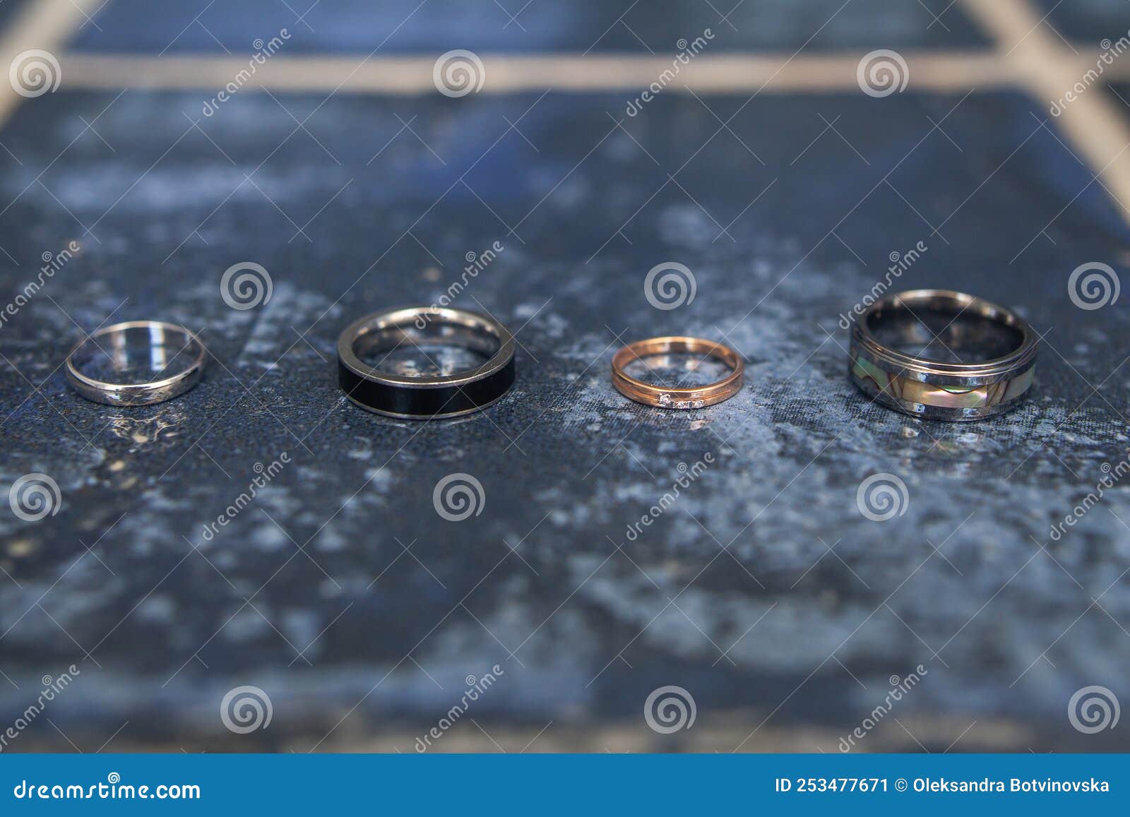 Four Wedding Rings on a Blue Tile Stock Image - Image of accessory ...