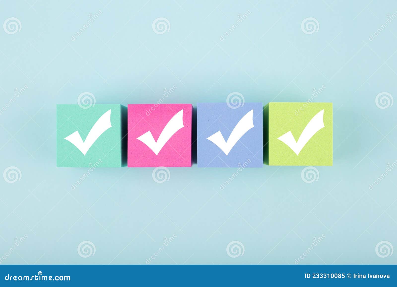 Four White Checkmarks on Multicolored Cubes in a Row Against Bright ...
