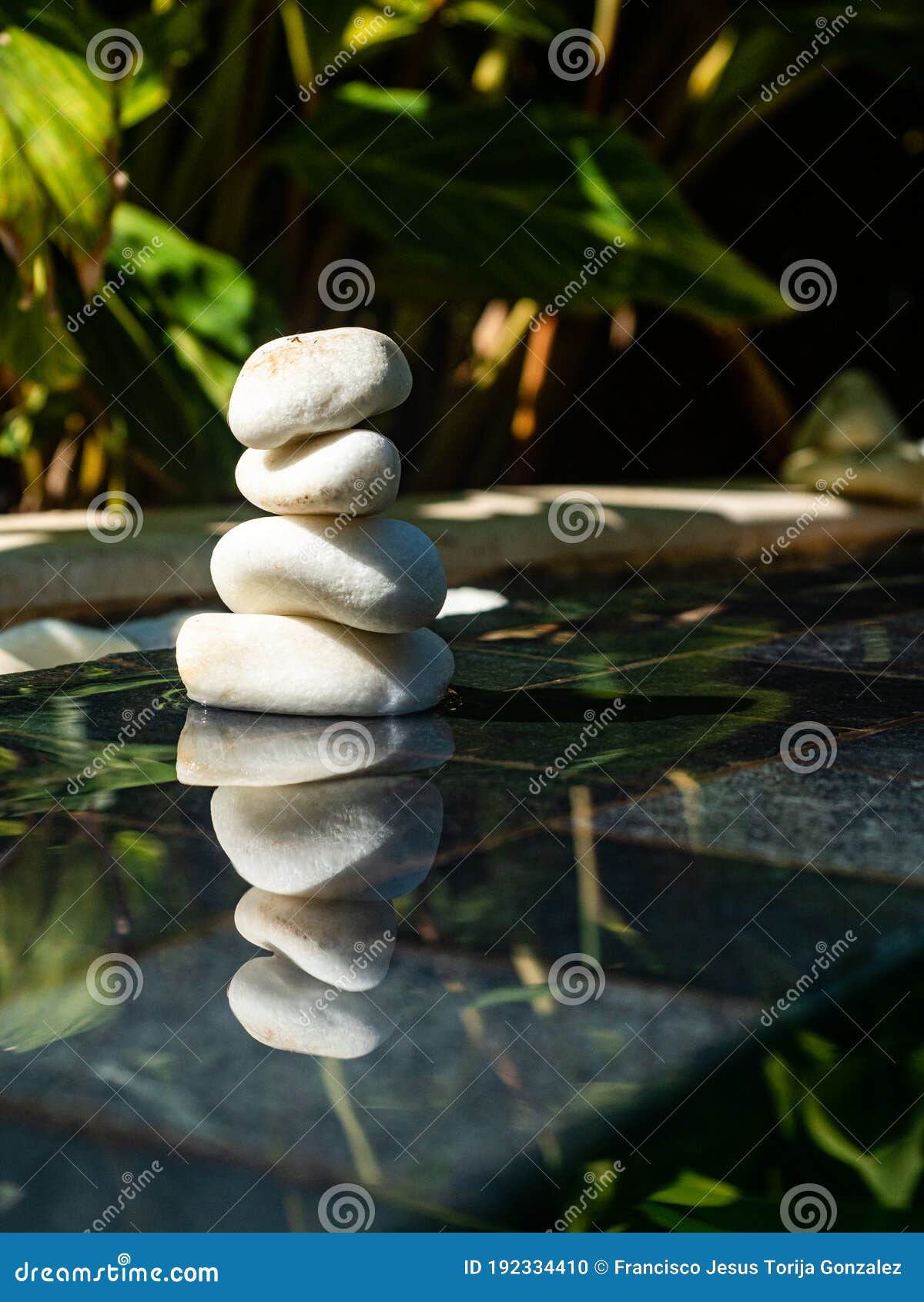FOUR WHITE STONES in BALANCE REFLECTED on the WATER Stock Photo - Image ...