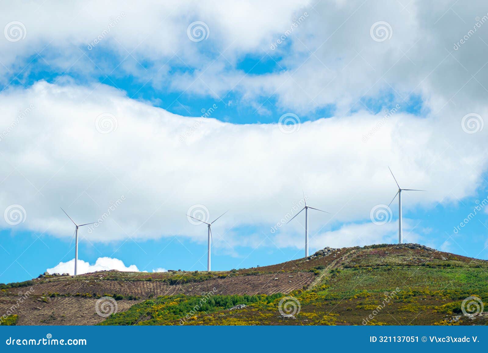 Four Windmills in a Mountain Wind Farm in Spring, Blue Sky with Clouds ...