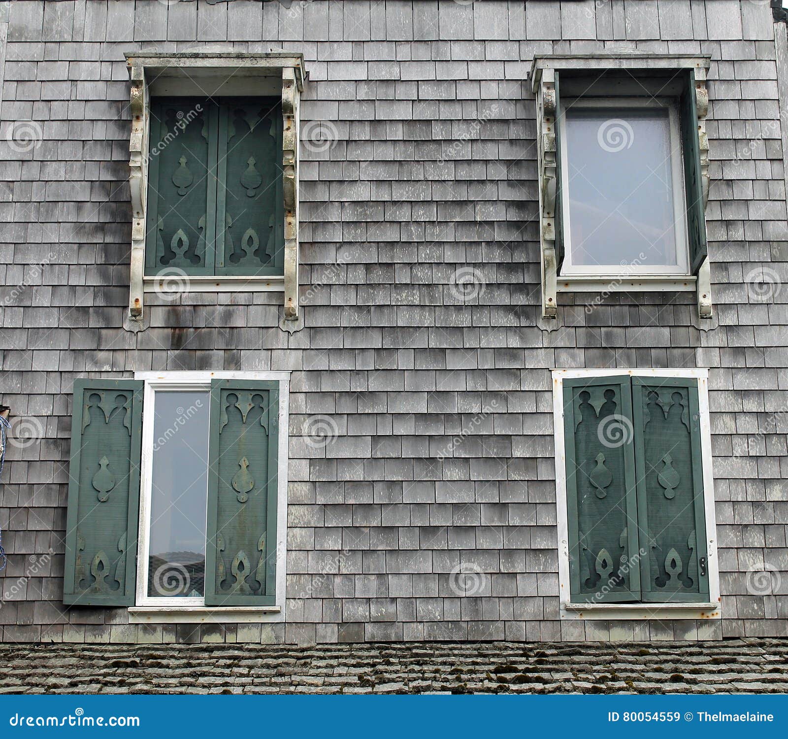 Four Windows with Decorative Shutters on an Old House Stock Image ...