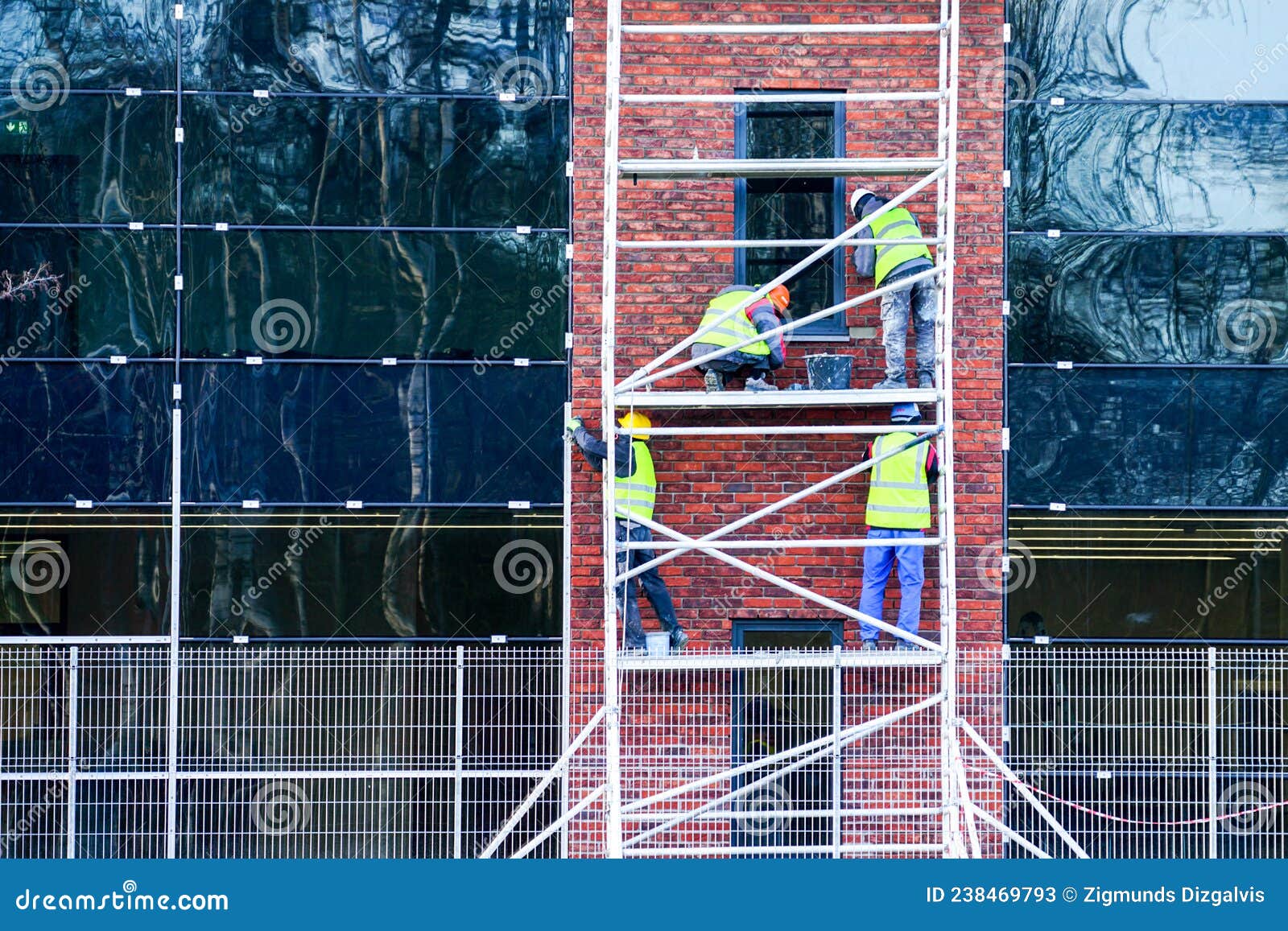 Four Workers on the Scaffolding Clean the Brick Facade of the Building Stock Image - Image of ...