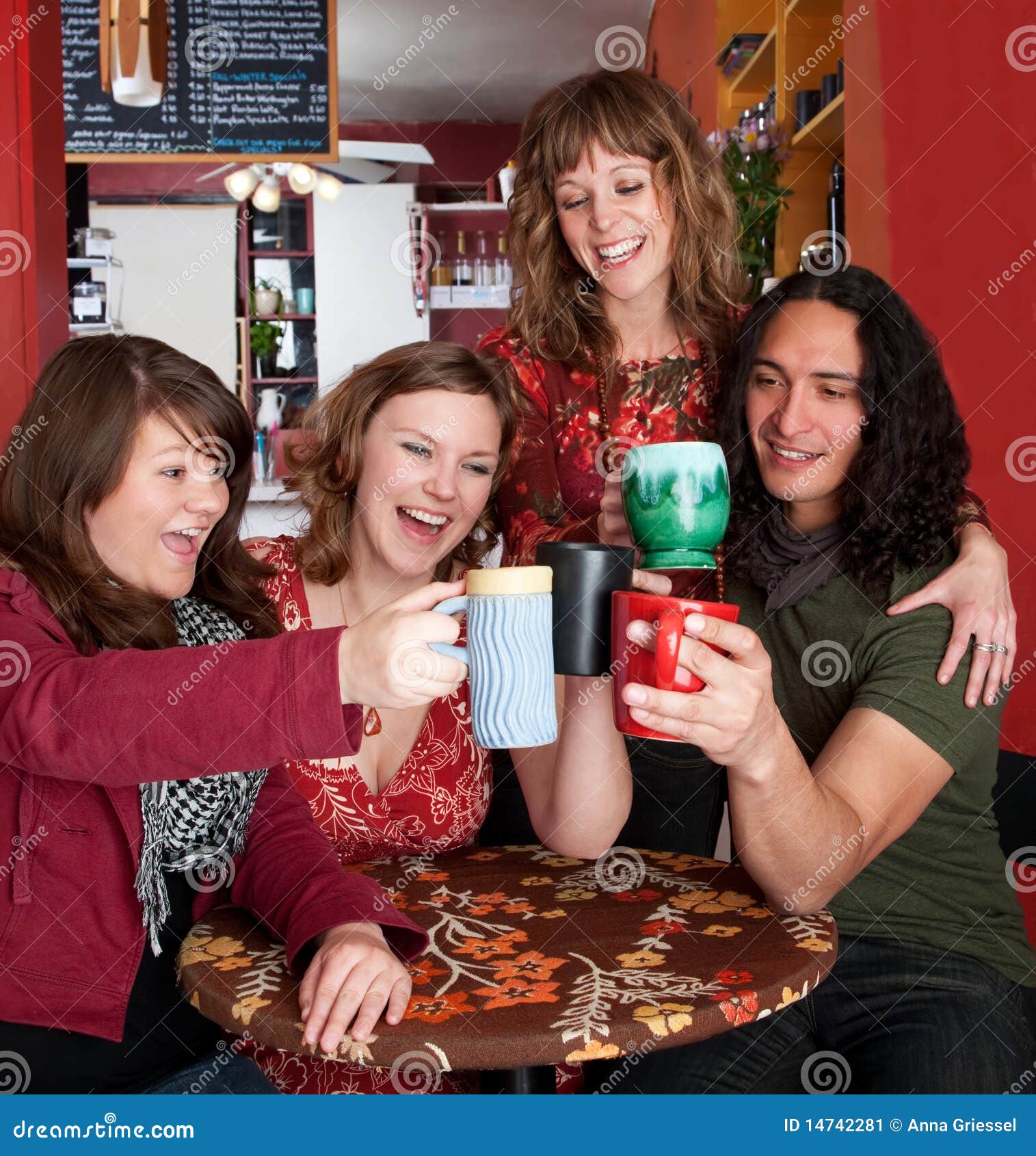 Four Young Friends Toasting at a Cafe Stock Image - Image of black ...