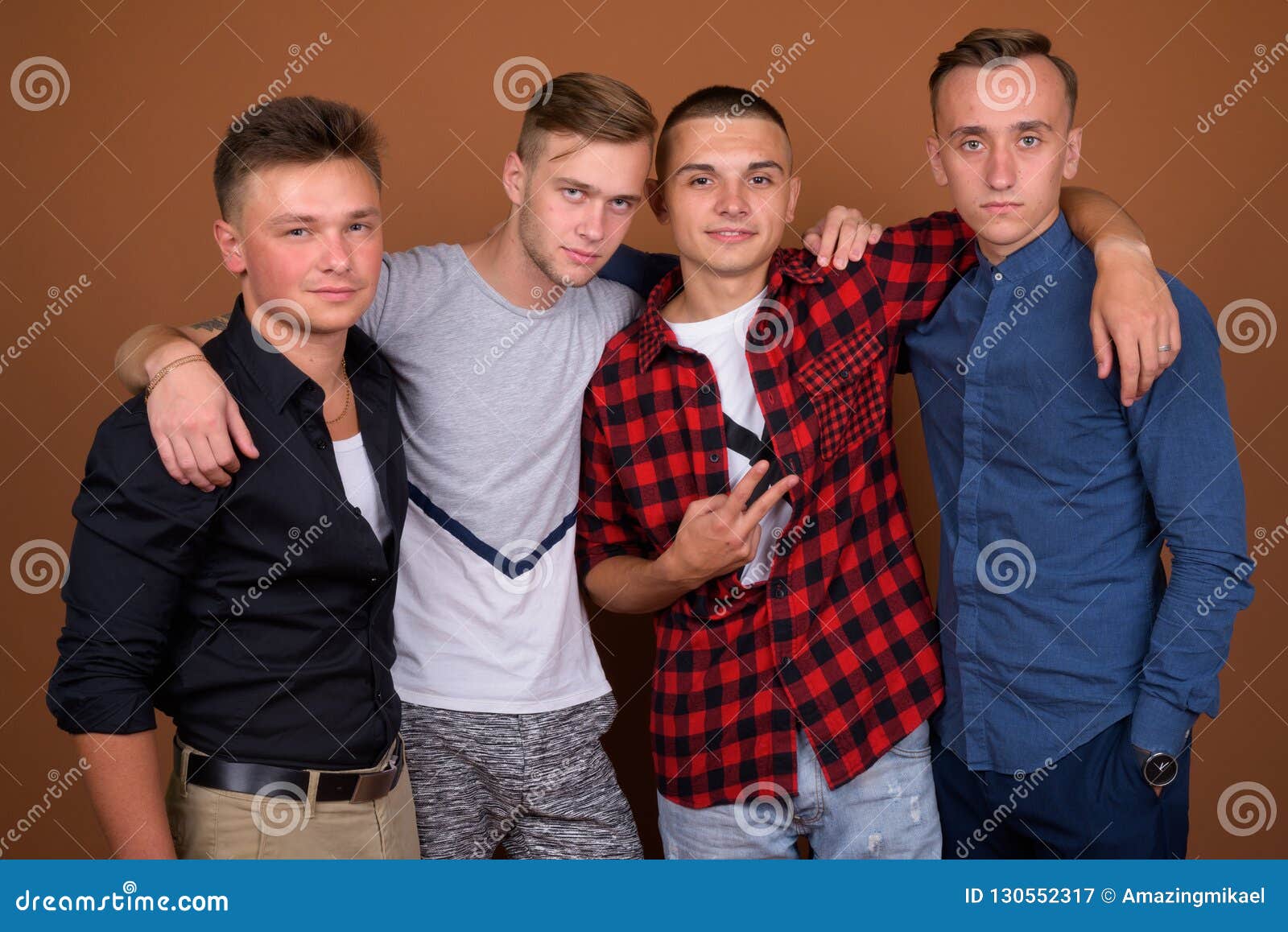 Four Young Handsome Men Together Against Brown Background Stock Image ...