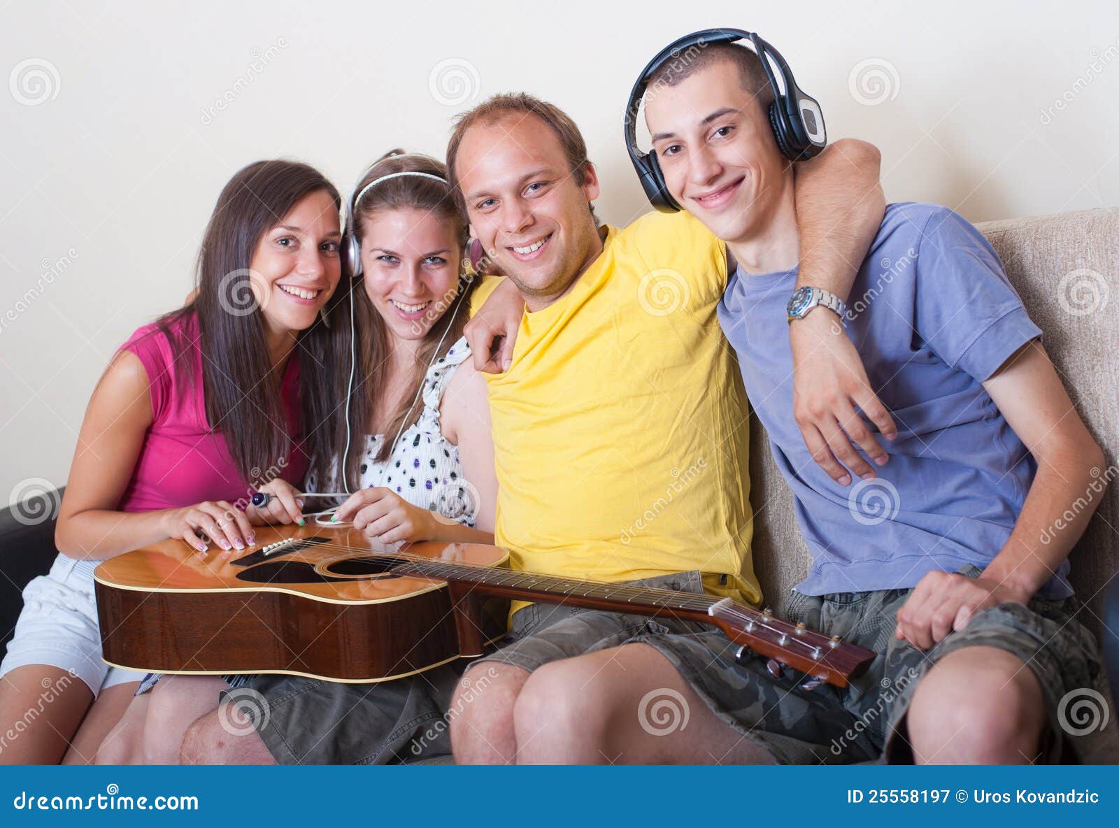 Four Young People with Guitar and Headphones Stock Image - Image of ...