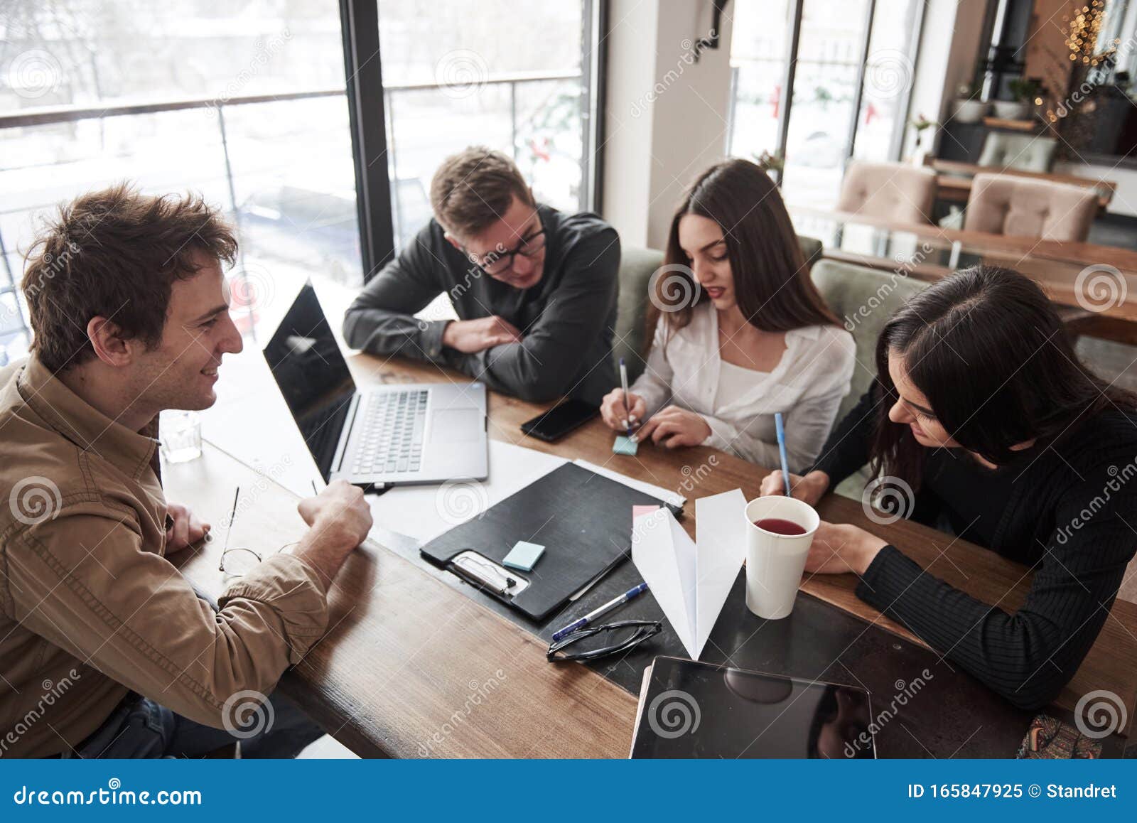 Four Young Students Working on the Project when Sitting in the Room ...