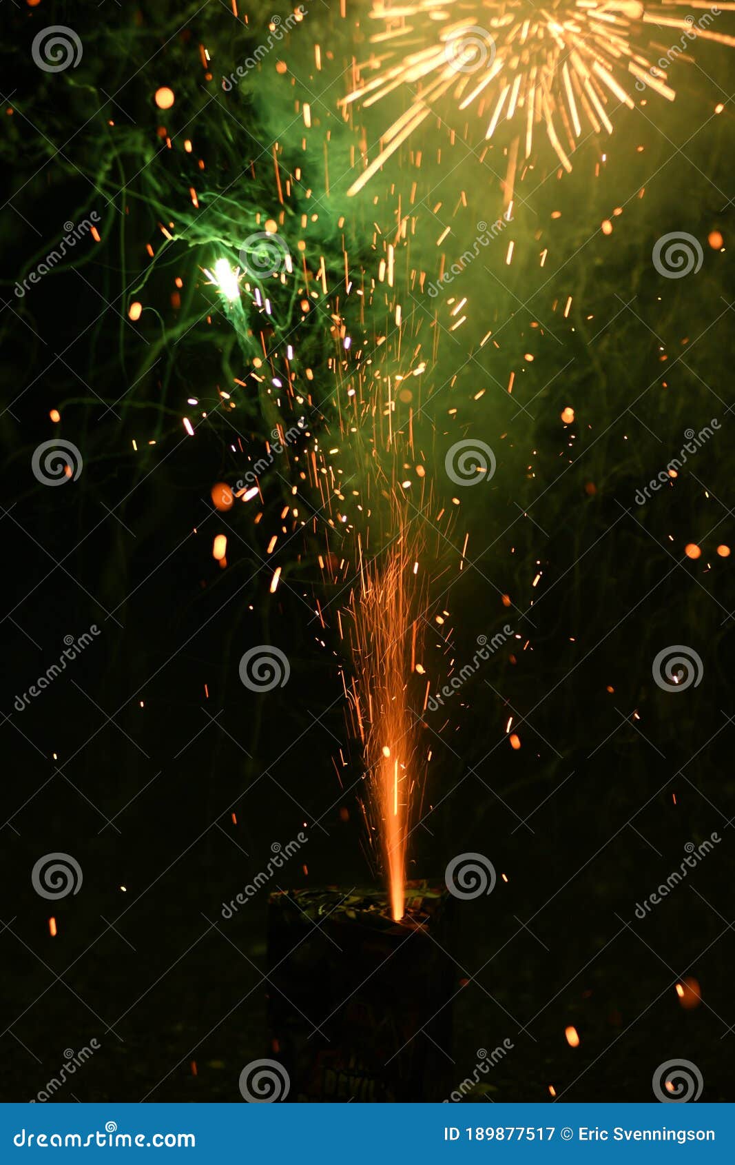 A Firework Exploding Green, Yellow, and Orange, in the Night Sky Stock ...