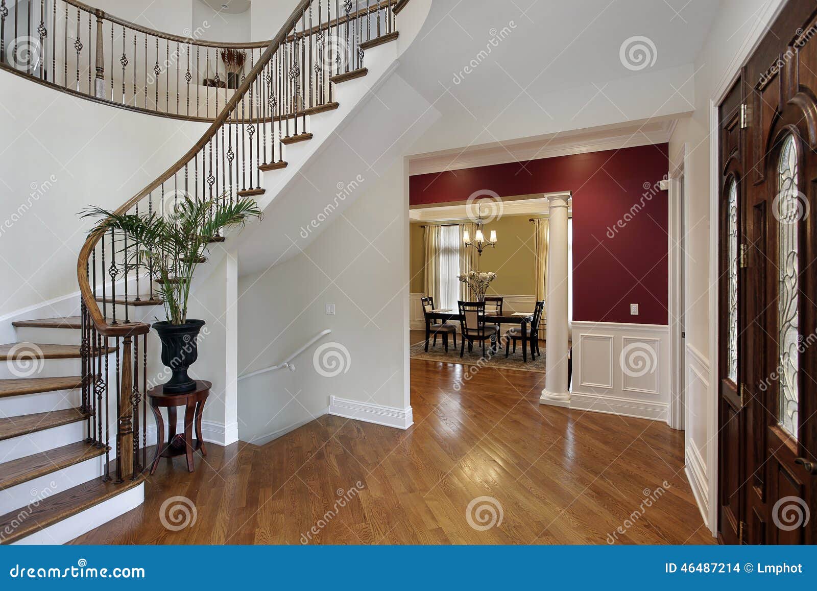 Foyer in Luxury Home with Curved Staircase Stock Photo - Image of ...