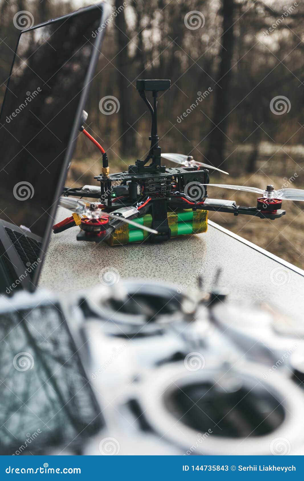 FPV Drone Lies on the Table Near the Laptop and Control Panel. Stock ...