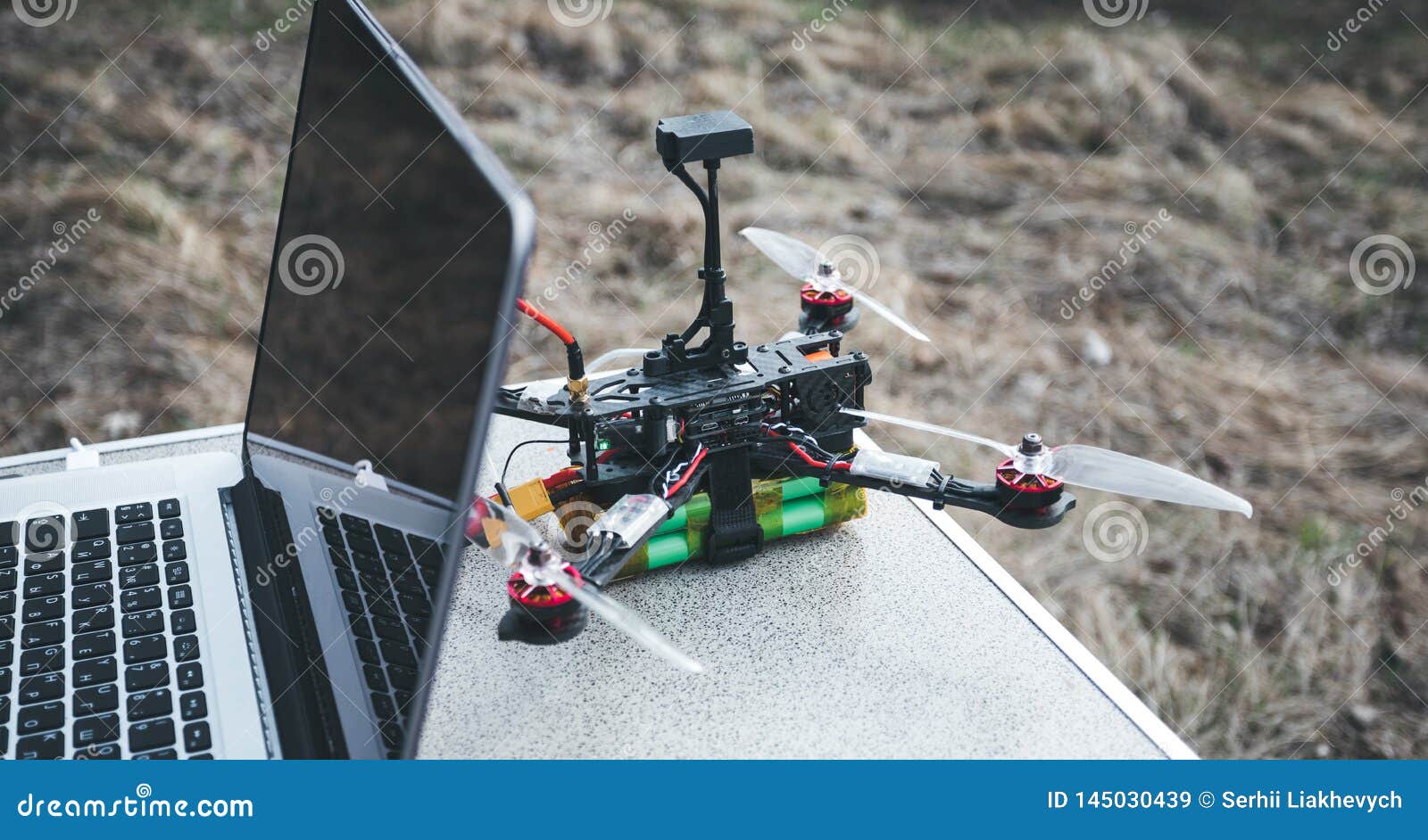 FPV Drone Lies on the Table Near the Laptop and Control Panel. Stock ...