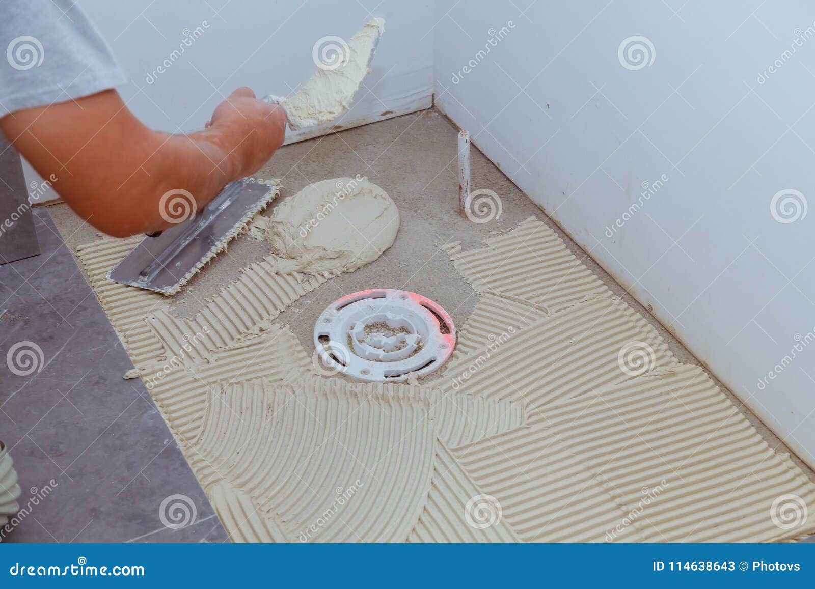 The Process Of Laying Ceramic Floor Tiles With A Herringbone Pattern ...