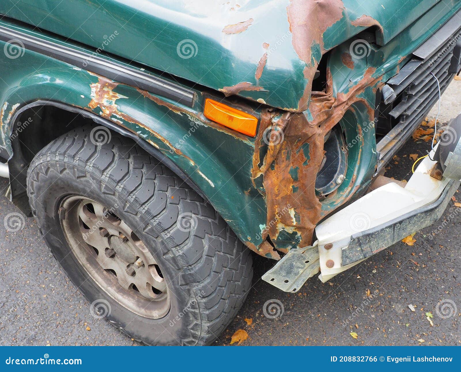 Fragment of a Green Car with a Broken Rusty Front Bent Bumper and No ...