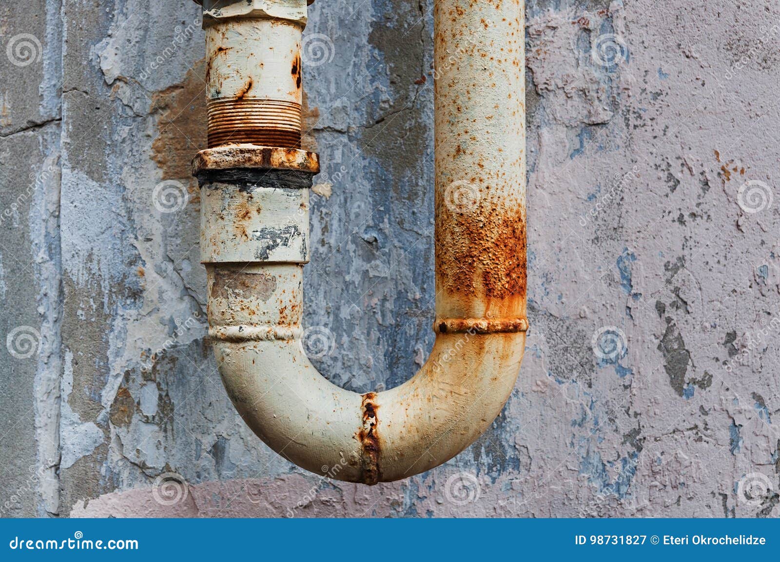 A Fragment of the Old Rusty Water Pipe on Shabby Wall Background Stock ...