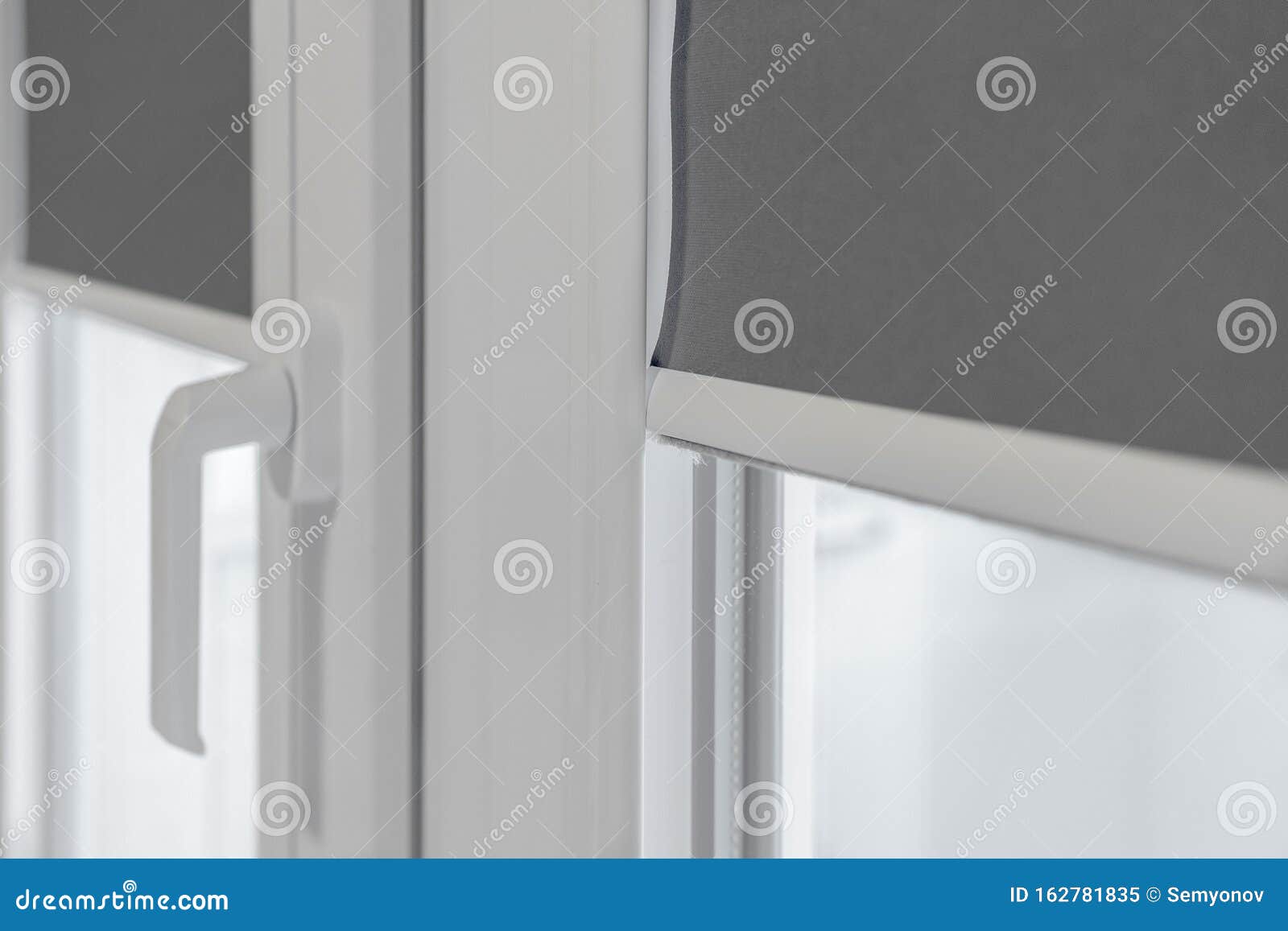 A Fragment of a Plastic Window. PVC Window with Lowered Roll-up Blinds ...