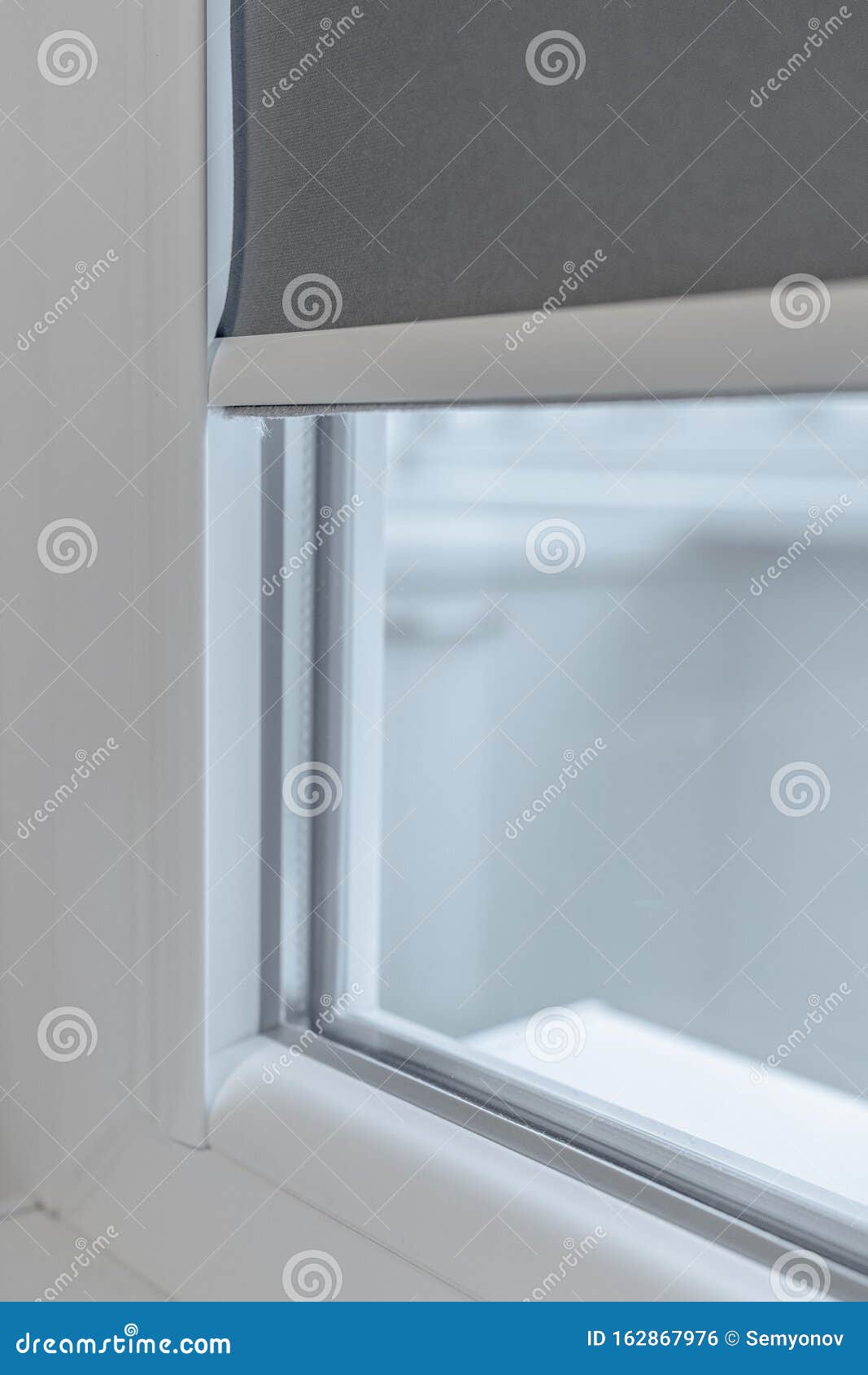 A Fragment of a Plastic Window. PVC Window with Lowered Roll-up Blinds ...