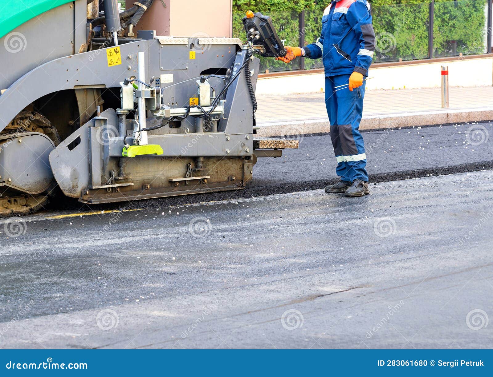 A Fragment of the Work of an Asphalt Paver Operator on a Town Road on a ...
