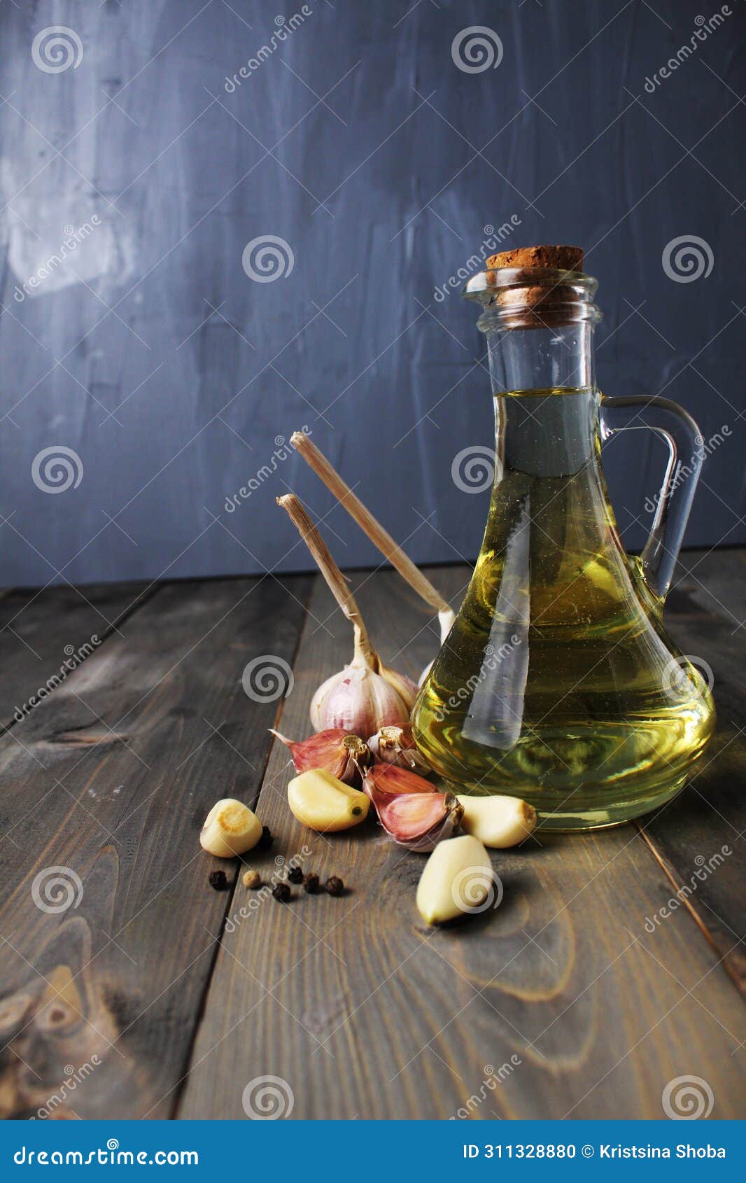 Fragrant Vegetable Oil with Garlic and Black Red Pepper on Grey ...