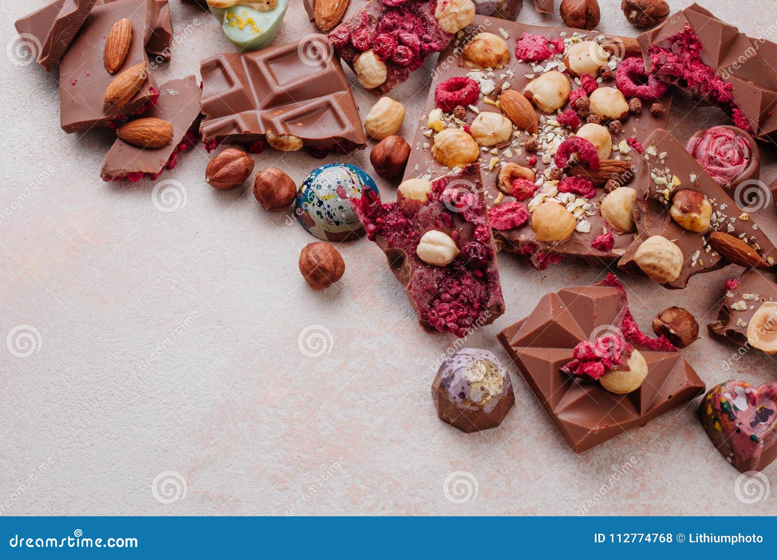 Frame of Broken Bars of Milk Chocolate with Nuts on Beige Background ...