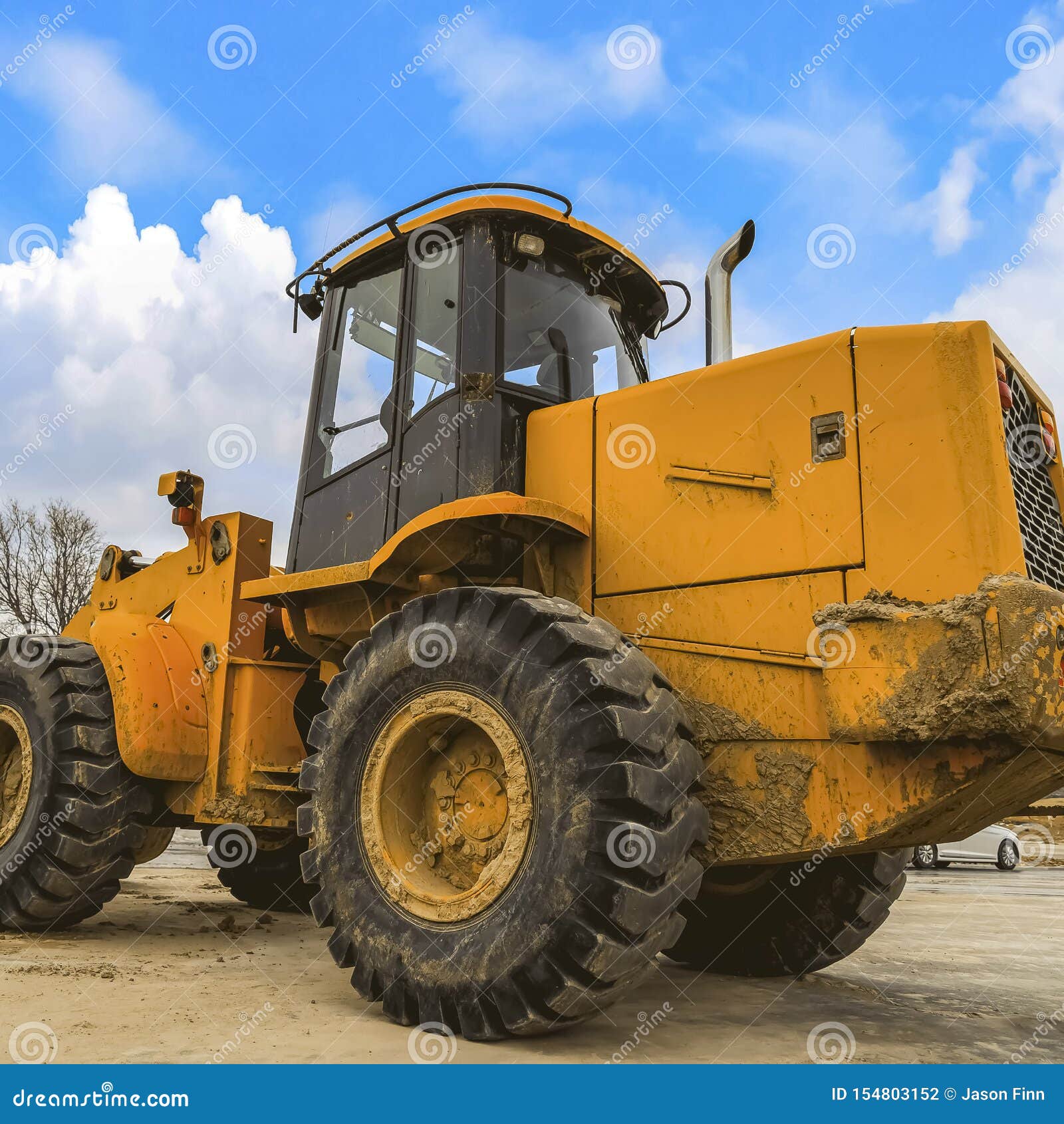 Frame Close Up of a Dirty Yellow Loader with Black Rubber Wheels and ...