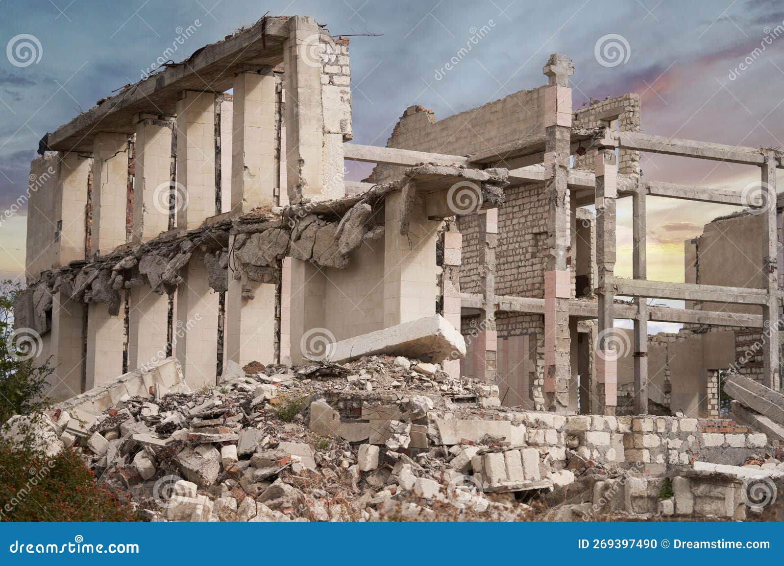 The Frame of the Destroyed Building with a Pile of Debris of Concrete ...