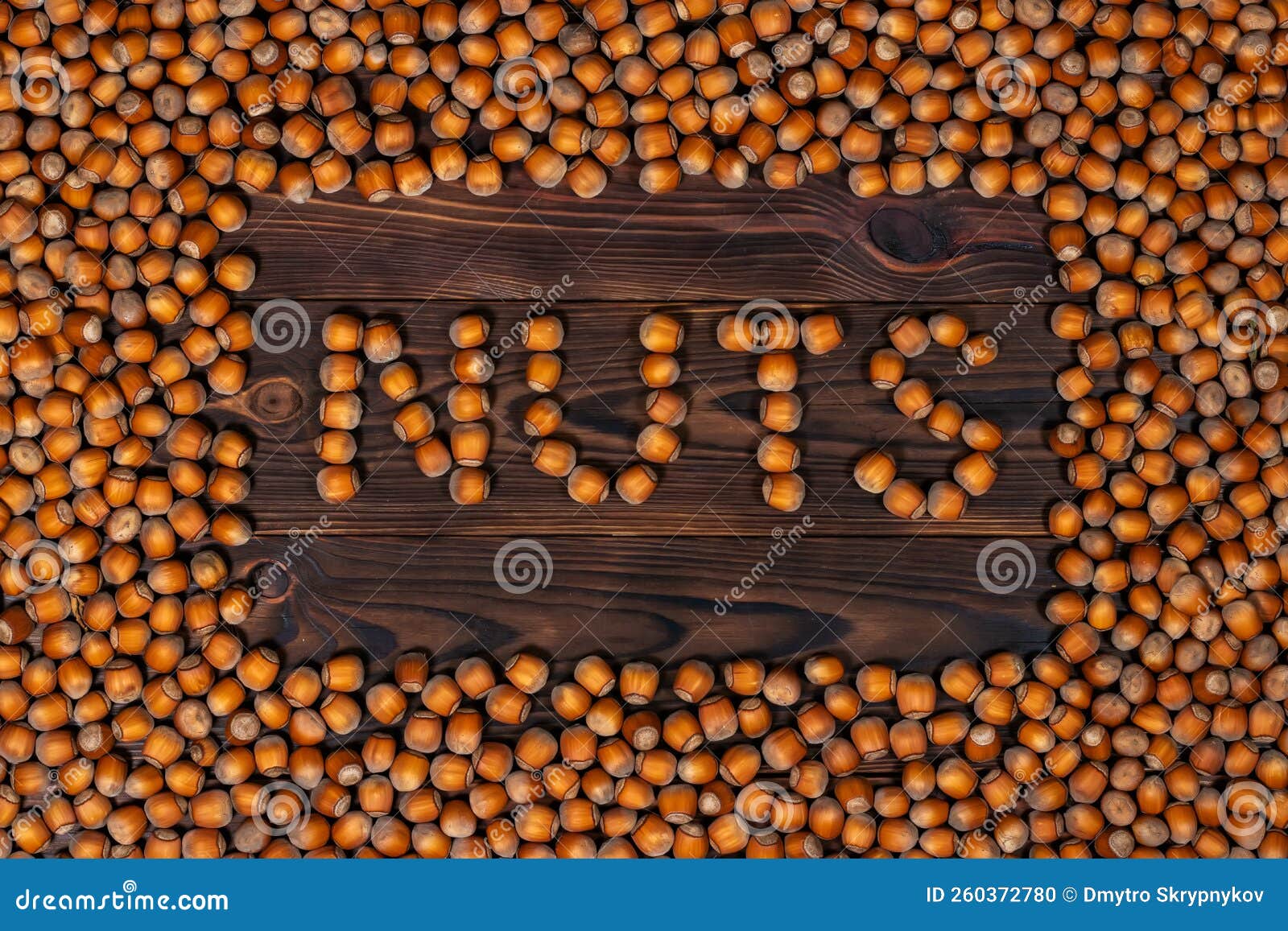 Frame of Hazelnuts with Shells on Brown Wooden Boards. the Word Nuts is ...
