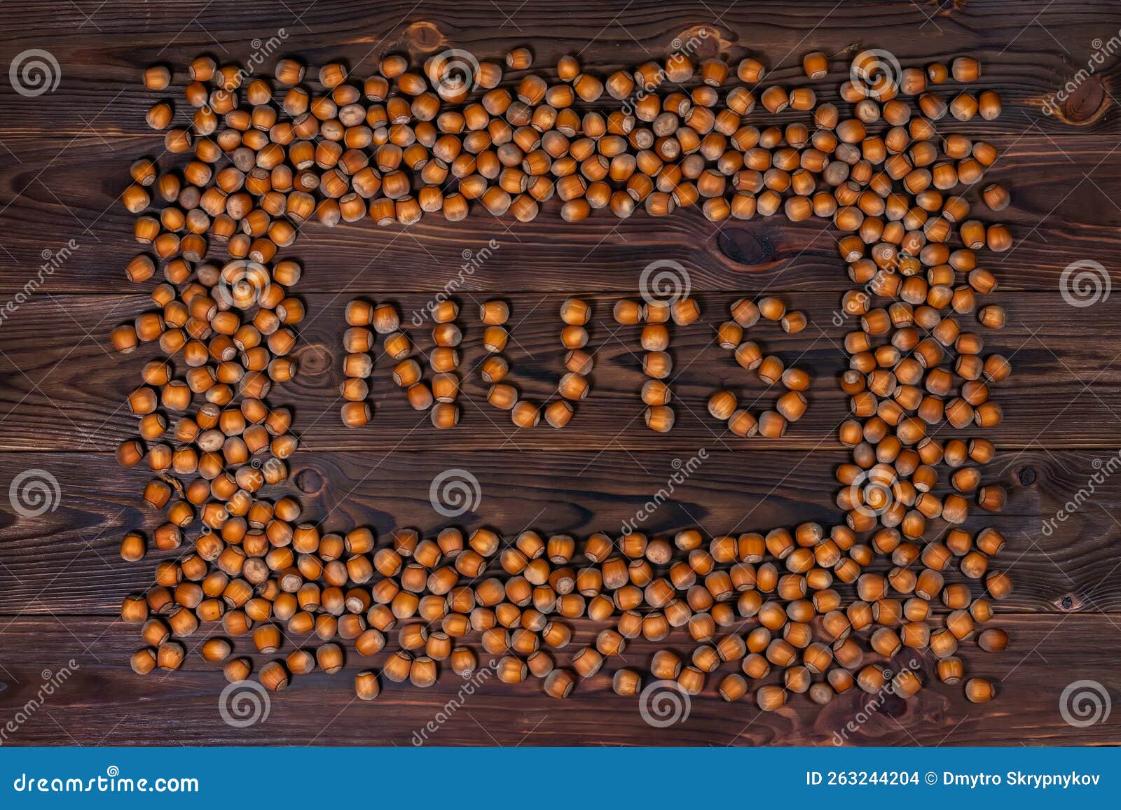 Frame of Hazelnuts with Shells on Brown Wooden Boards. the Word Nuts is ...