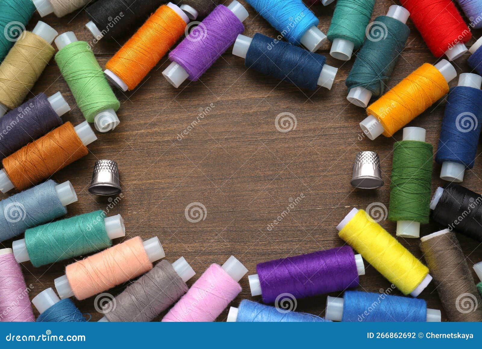 Frame Made of Colorful Threads and Sewing Thimbles on Wooden Table ...