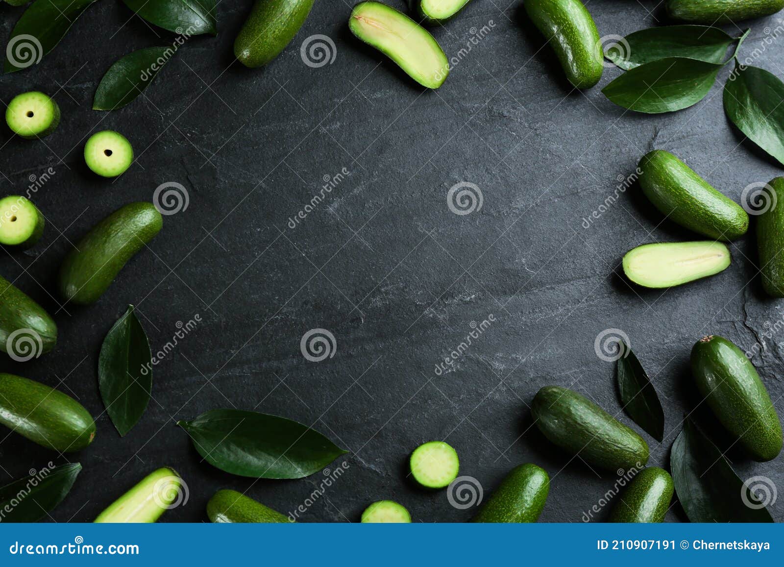 Frame Made of Fresh Seedless Avocados with Green Leaves on Dark Table ...