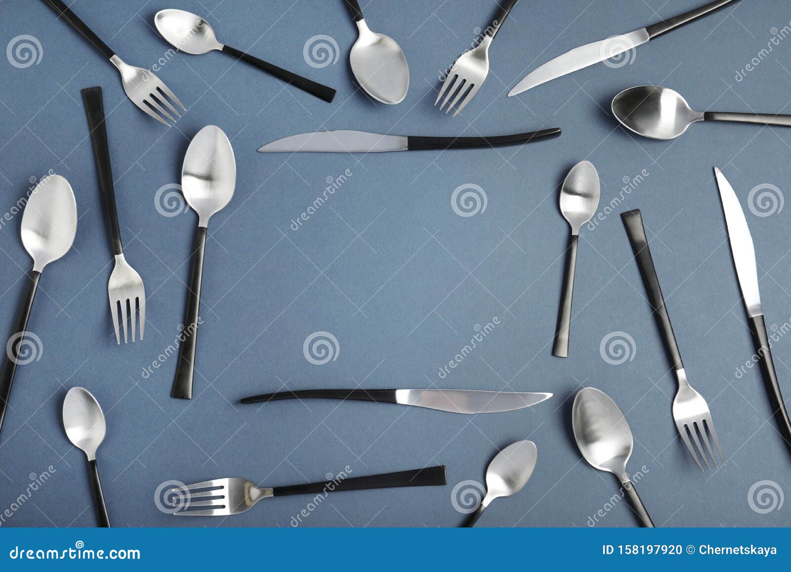 Frame Made of Steel Cutlery on Grey Background, Top View Stock Photo ...