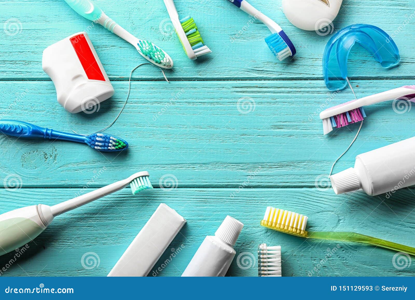 Frame Made of Toothbrushes, Paste and Dental Floss on Wooden Background ...