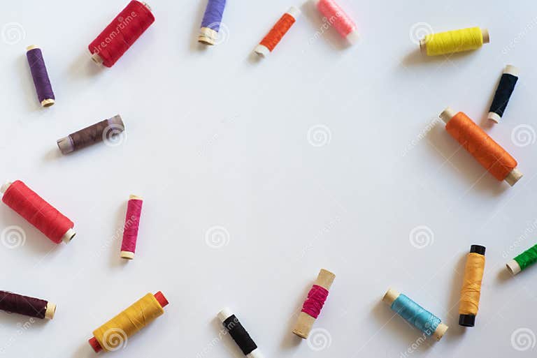 Frame with Multi-colored Reels with Threads on a White Background. Top ...