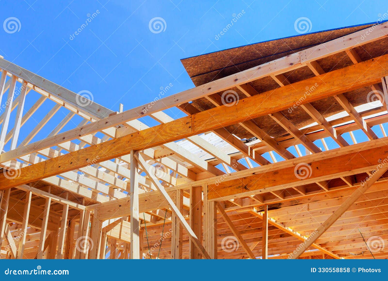 Frame of New Home with Wooden Truss, Post Beams Framework on a Construction Site Stock Photo ...