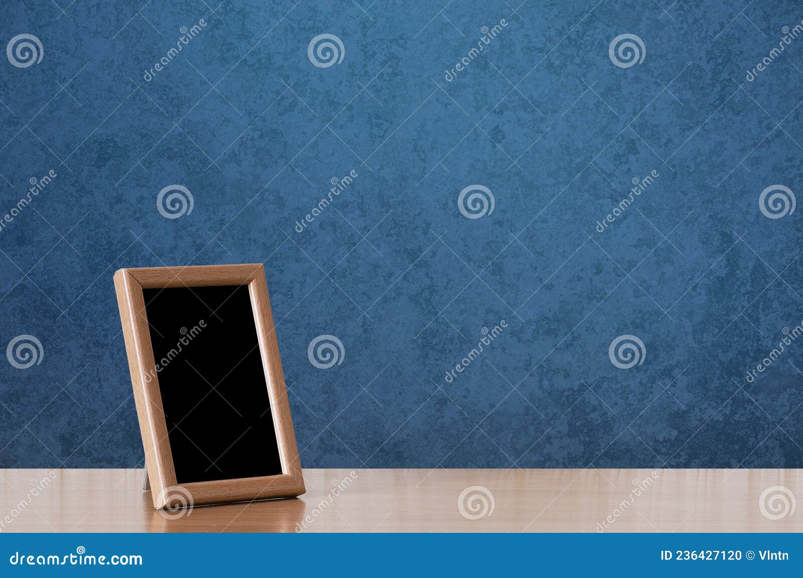 Frame on table, blue wall stock photo. Image of decorate - 236427120