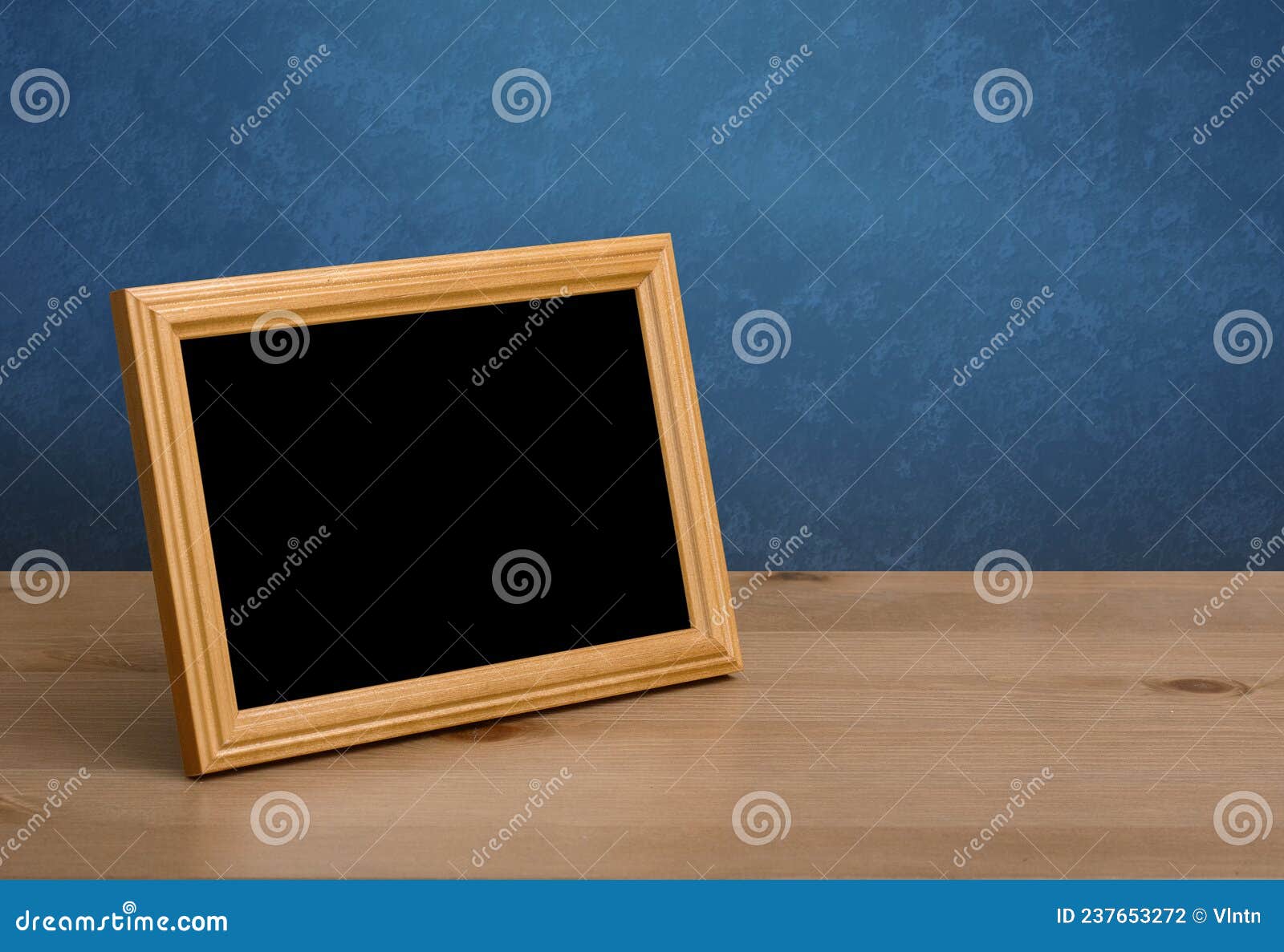 Frame on table, blue wall stock photo. Image of texture - 237653272