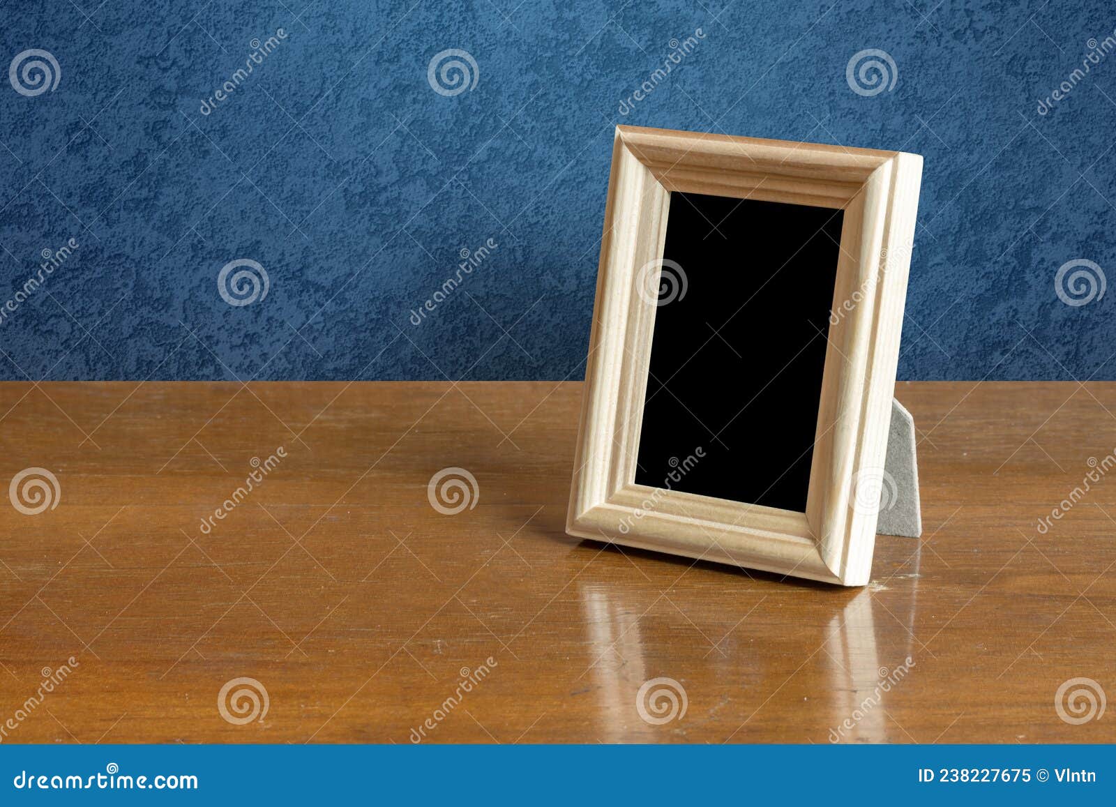 Frame on table, blue wall stock image. Image of decorate - 238227675