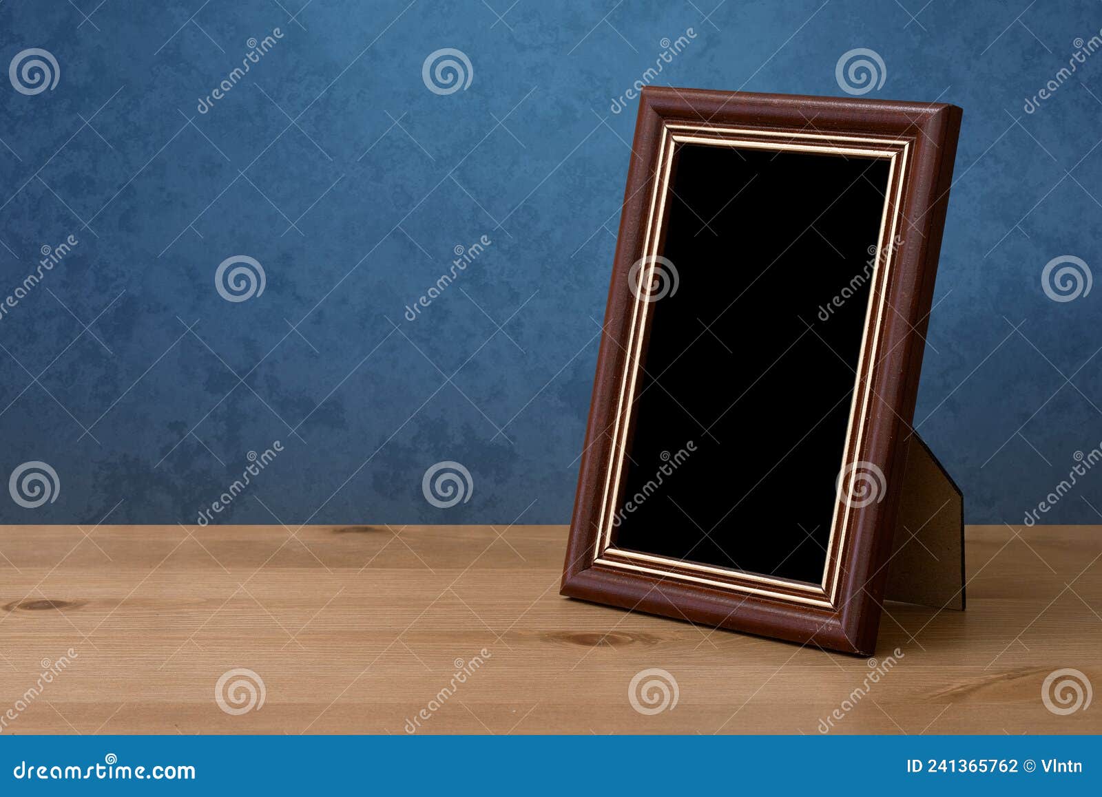 Frame on table, blue wall stock photo. Image of gallery - 241365762
