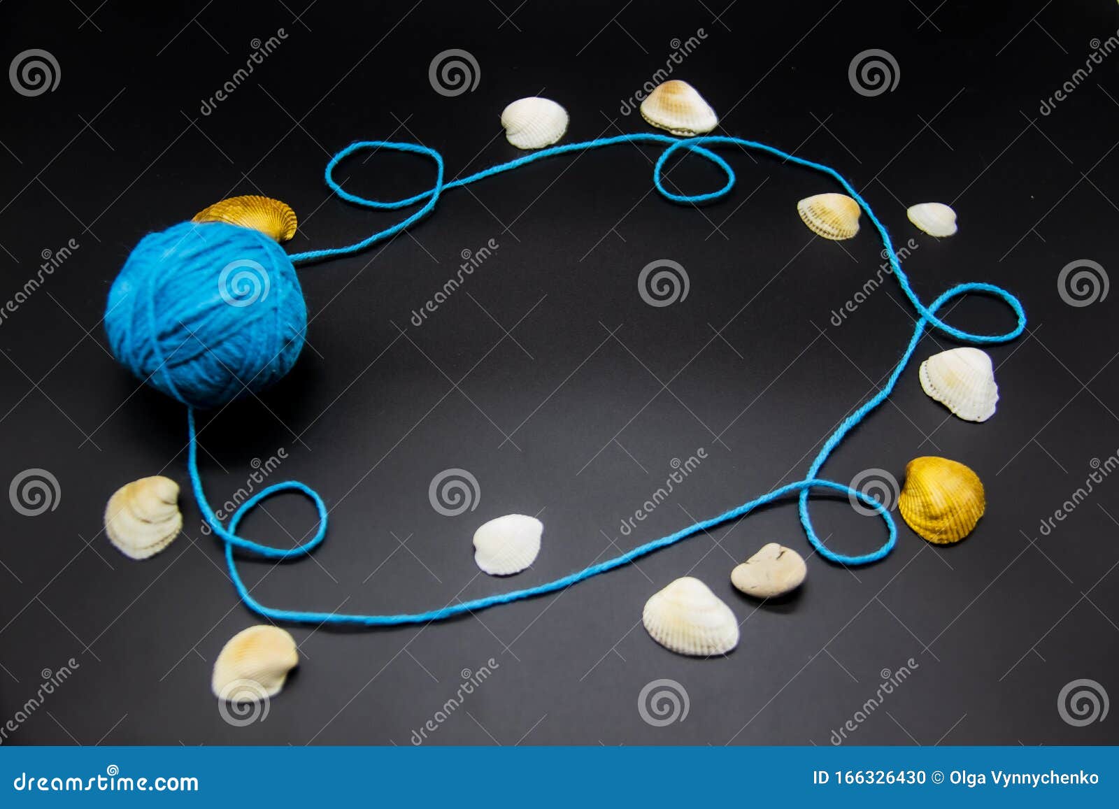 A Frame with Threads and Shells on a Black Background. a Blue Skein of ...