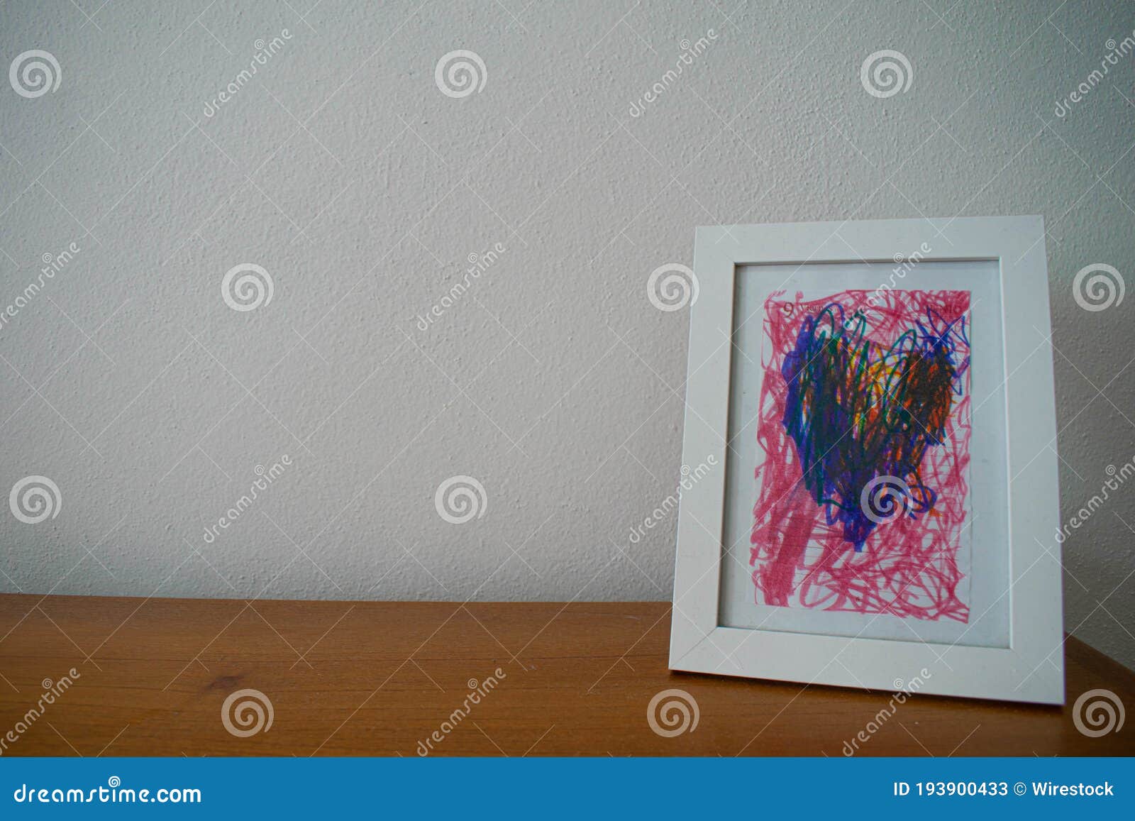 Framed Drawing Done by a Child Placed on a Table at Home Stock Image ...