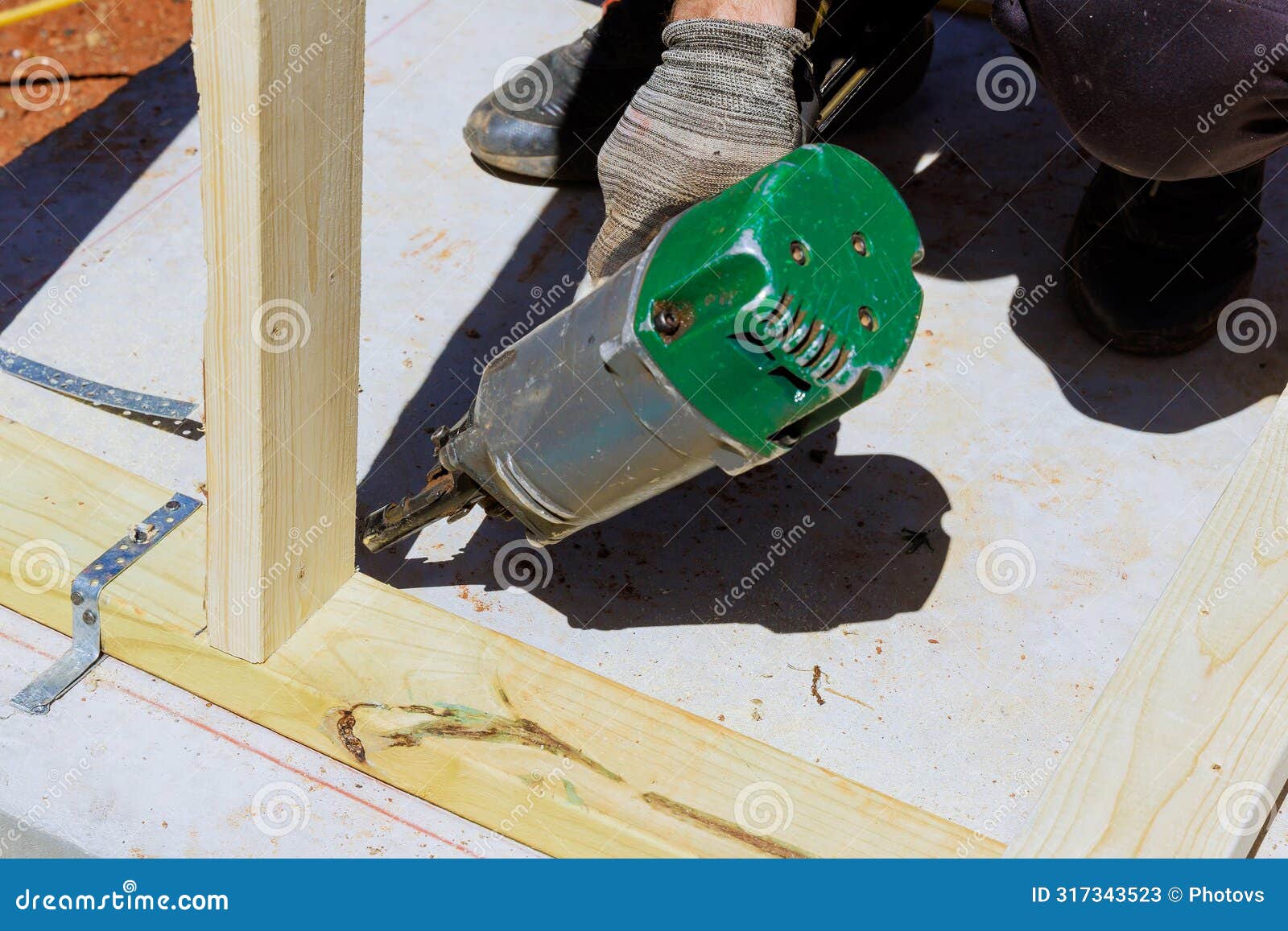 Framer Worker Installing Beams Using Air Nails Hammer in a Nailing ...