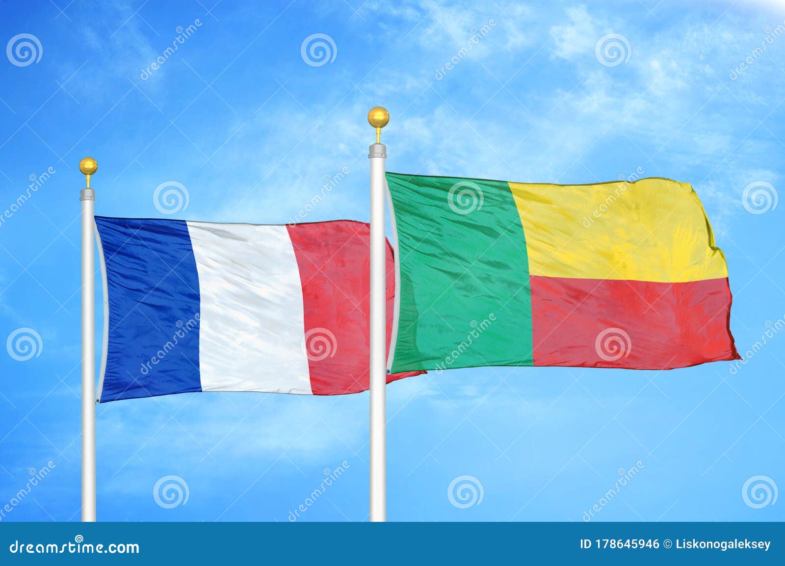 France and Benin Two Flags on Flagpoles and Blue Cloudy Sky Stock Photo ...