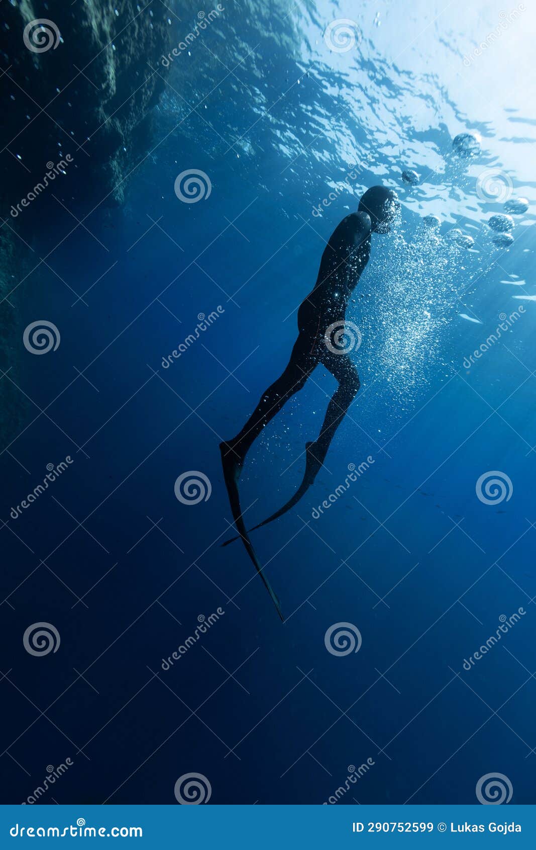 Freediver Swimming in Deep Sea with Sunrays Stock Image - Image of ...