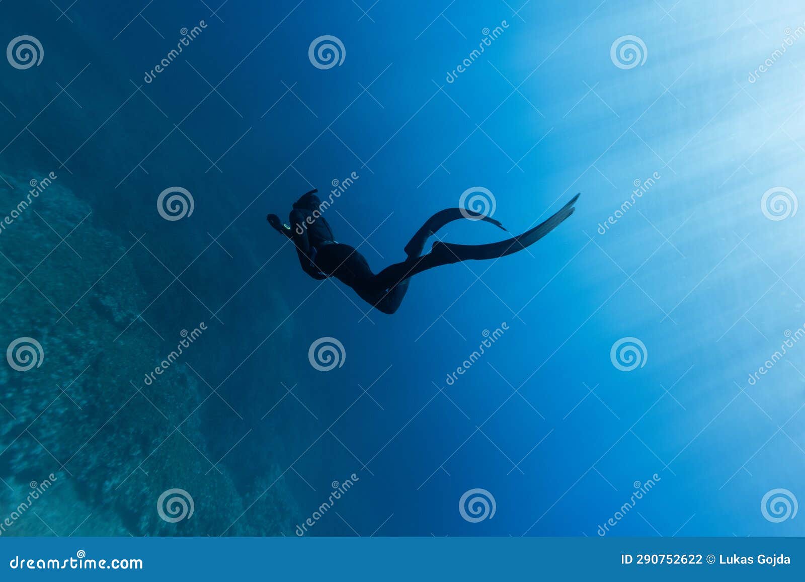 Freediver Swimming in Deep Sea with Sunrays Stock Photo - Image of ...